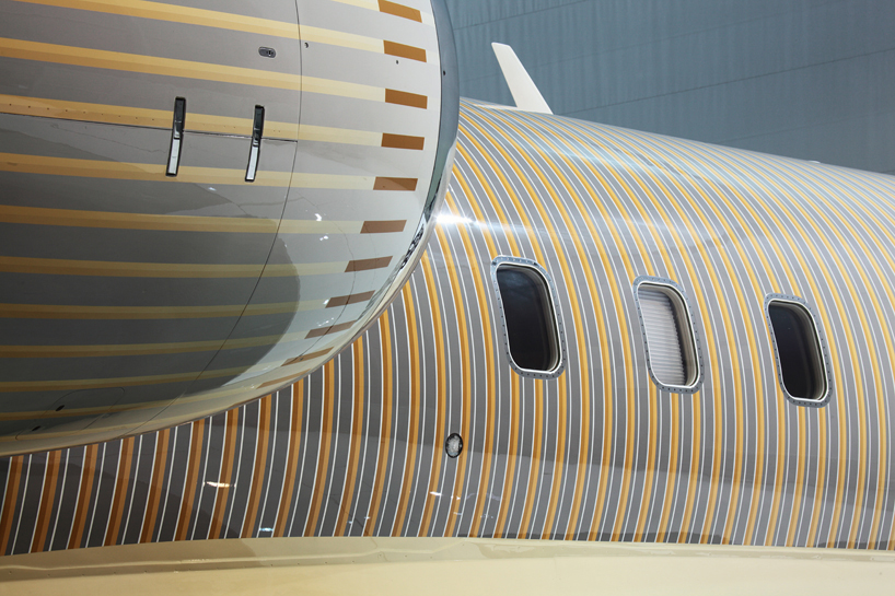 happy design studio wraps private jet in gradient stripe pattern