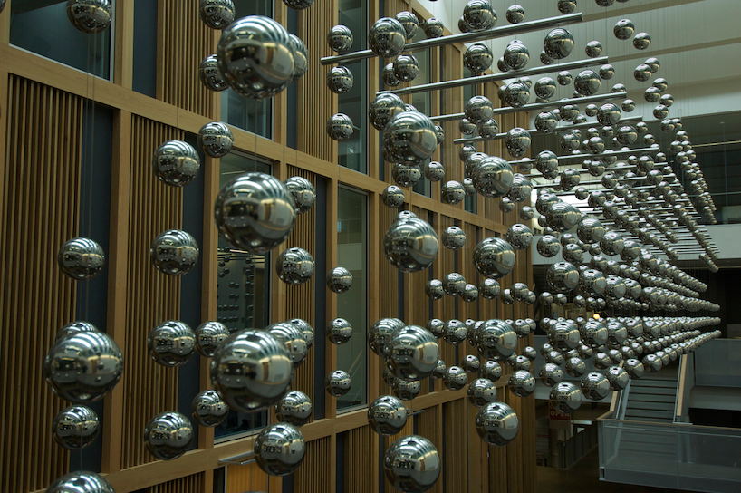 abacus sculpture by ray king floats polished spheres of stainless steel