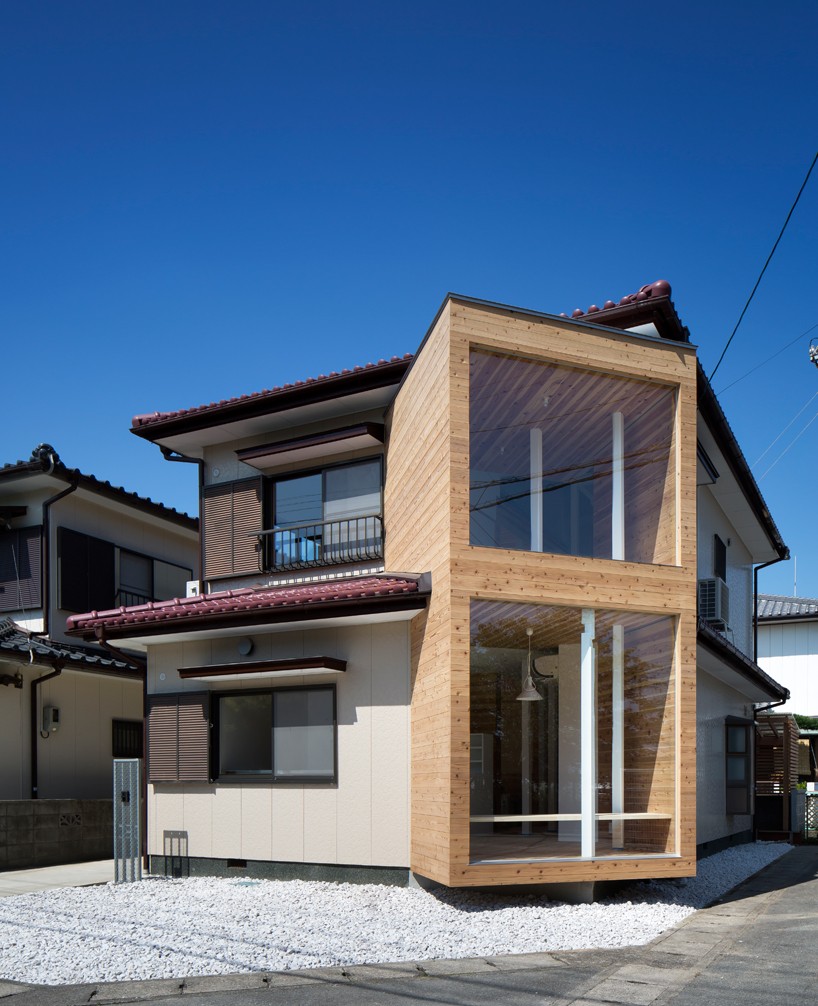 container design protrudes timber volume from traditional japanese home
