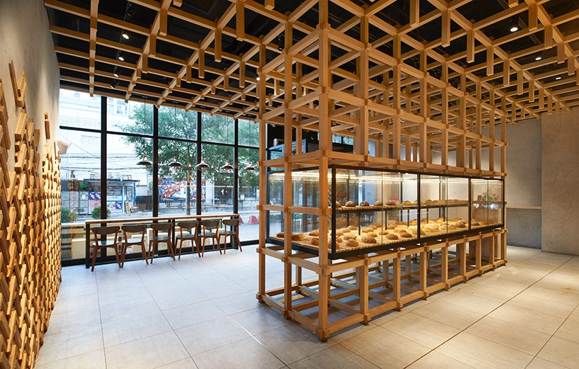 B.L.U.E architecture studio crafts timber framework inside withwheat