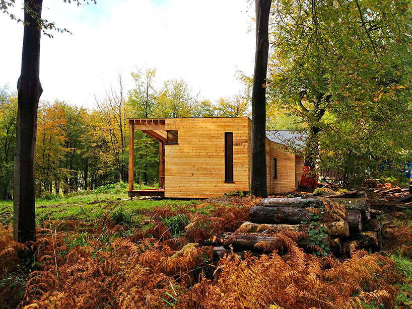 invisible studio designs caretaker's house with a variety of local timber