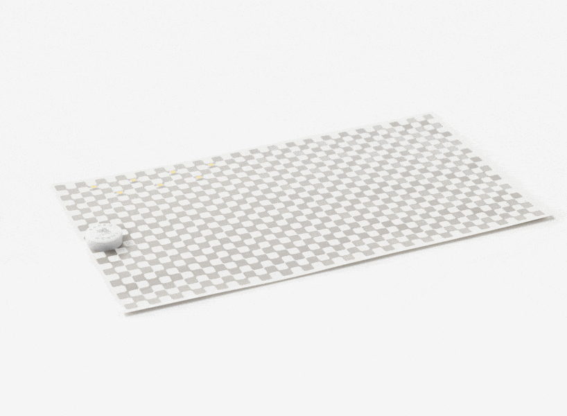 nendo's paper torch is an electronic paper that rolls itself up into a lamp