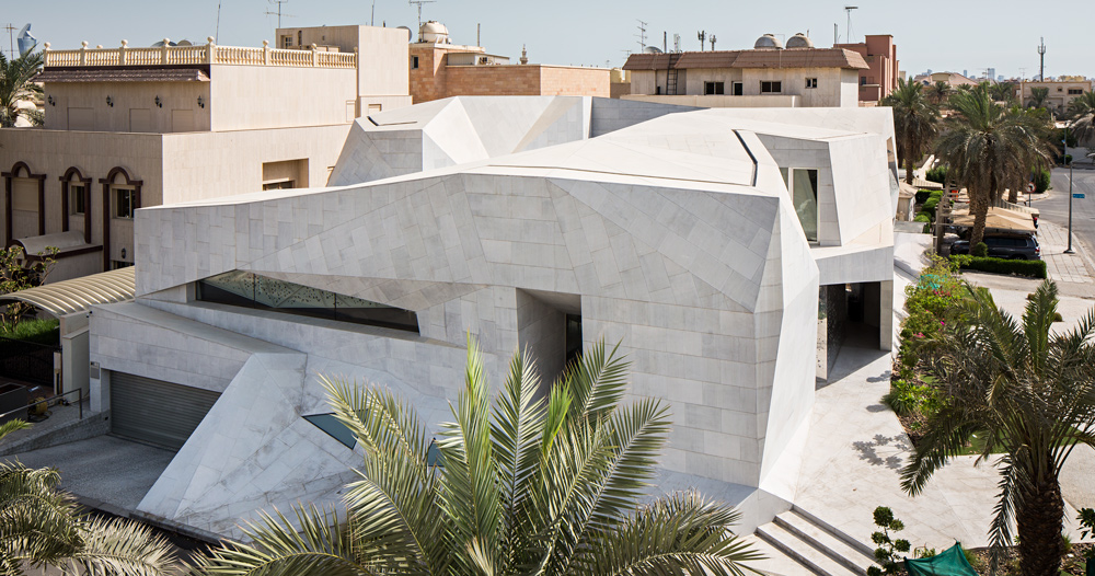 rock house by AGi architects is clad with concrete 'origami'