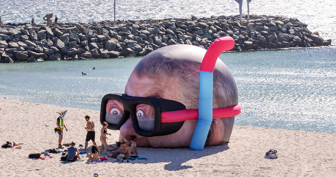 inflated damien hirst head pops up on perth beach, snorkeling for ...
