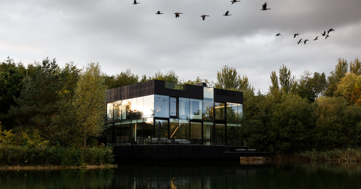 mecanoo completes glass + burnt wood villa on a british lake
