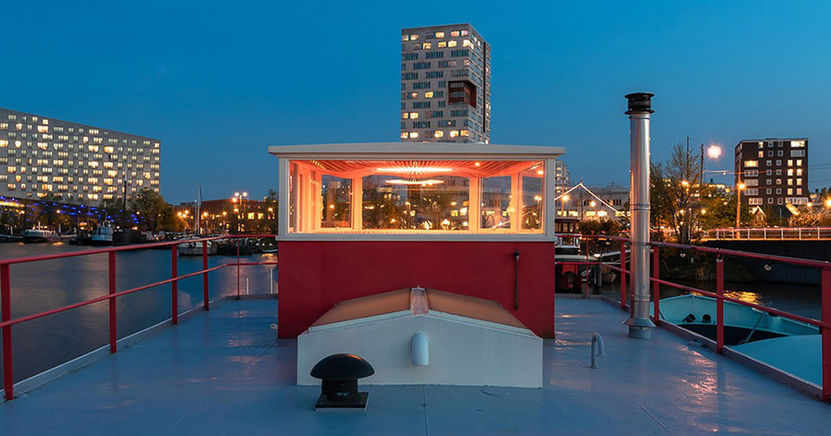 mass design materializes wave in wood for lighthouse in amsterdam boat