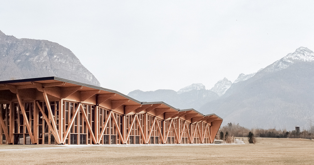rhythmic timber structure punctuates the vast northern italian landscape