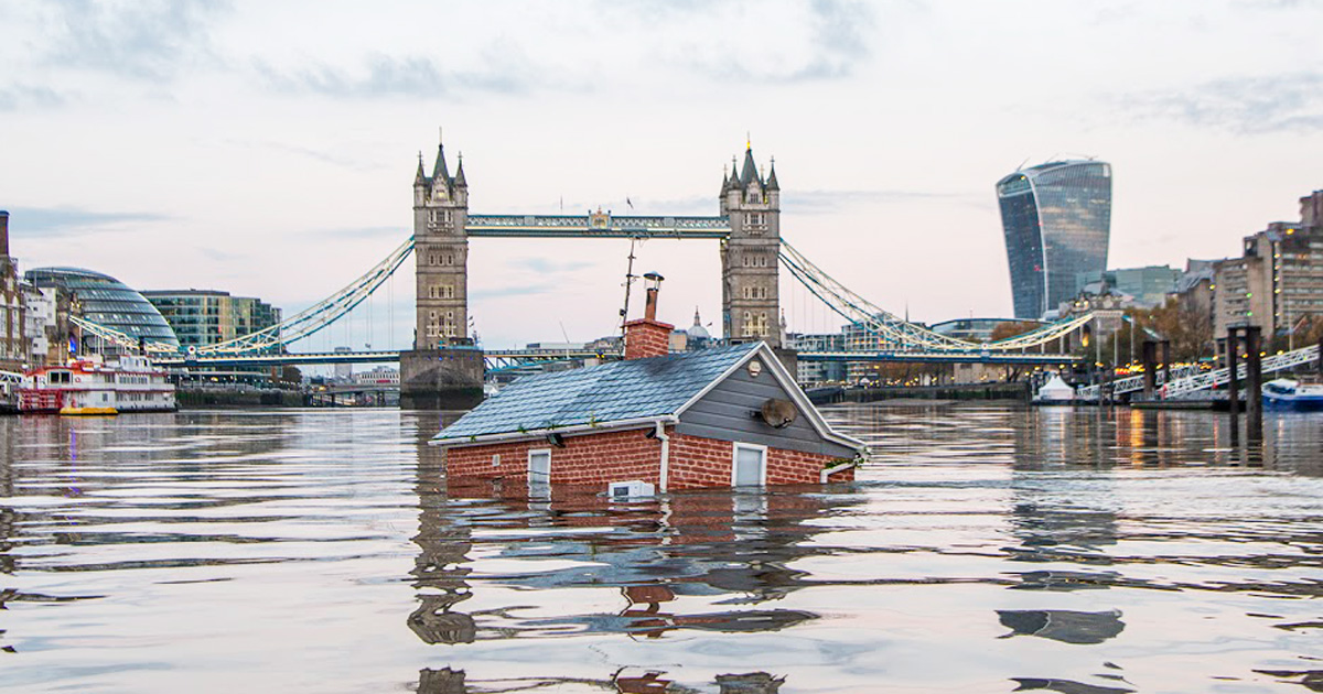 extinction rebellion drops 'sinking house' in the river thames