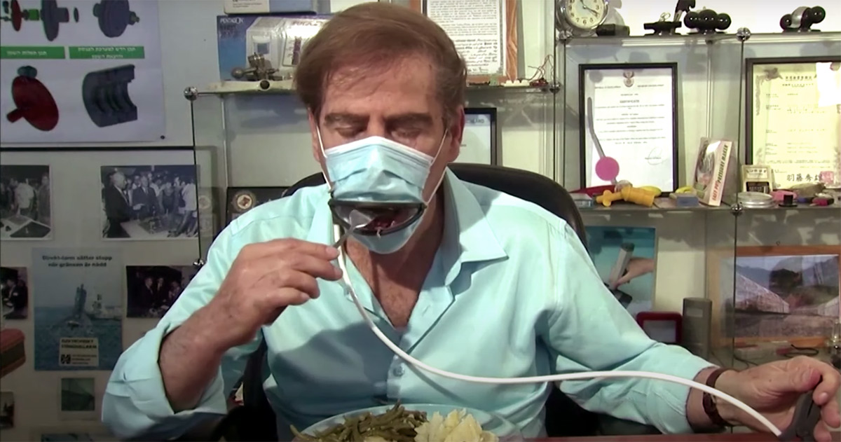 this face mask has a hinged mouth so it can be worn while eating