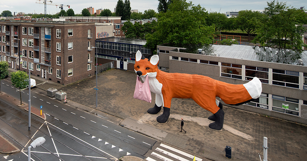 florentijn hofman's gigantic fox wanders through grey streets of rotterdam