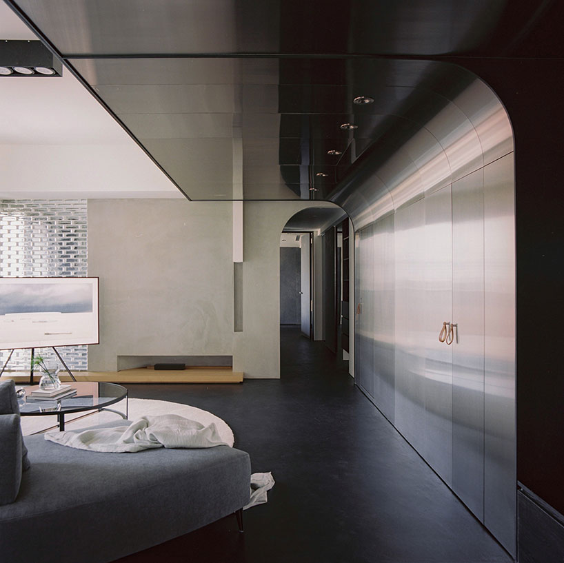 stainless steel wall reflects daily life within minimalist interior by ...