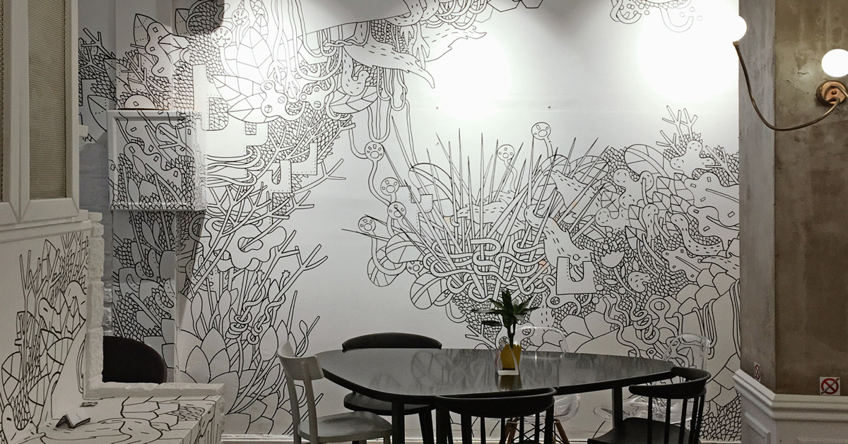 freehand monochrome mural by stefanos papadimos adorns solasta cafe's ...