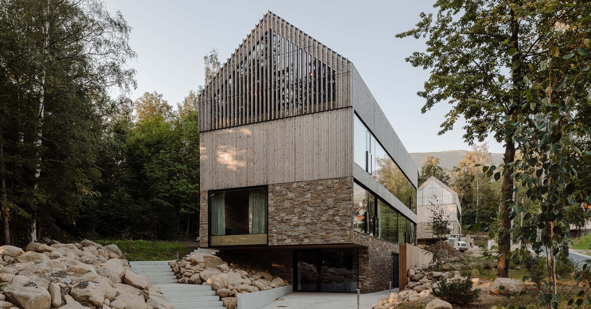 studio de.materia clads twin apartment buildings in stone + wood in poland