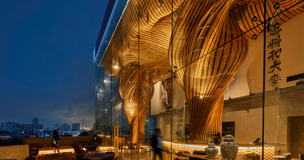 billowing rattan columns by enter projects occupy bangkok's spice & barley