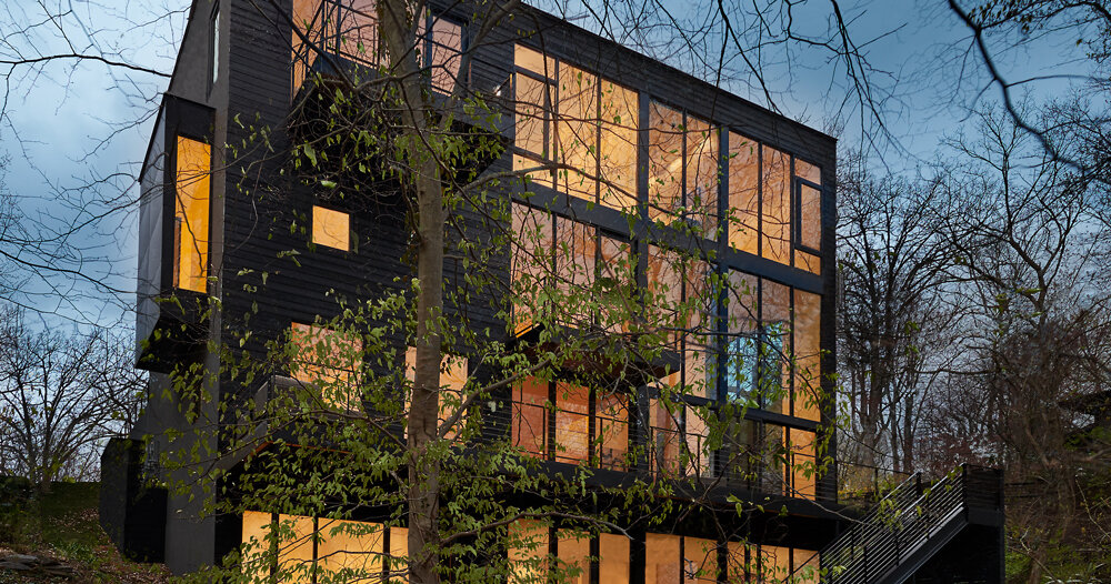 robert gurney architect's luminous facade opens toward its forested site