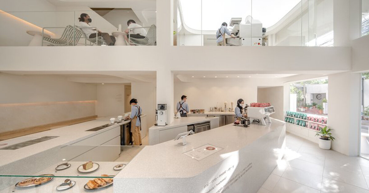 warm neutrals and soft curves shape PAGA microroastery in bangkok