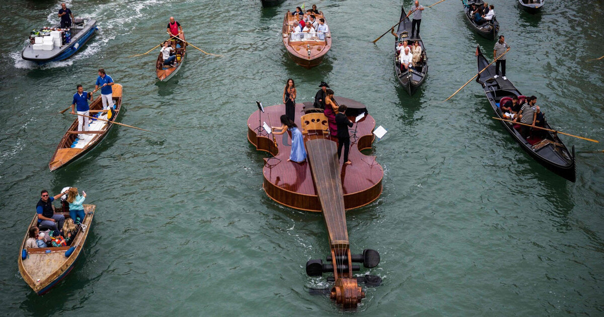giant violin floats down venice's grand canal complete with string quartet