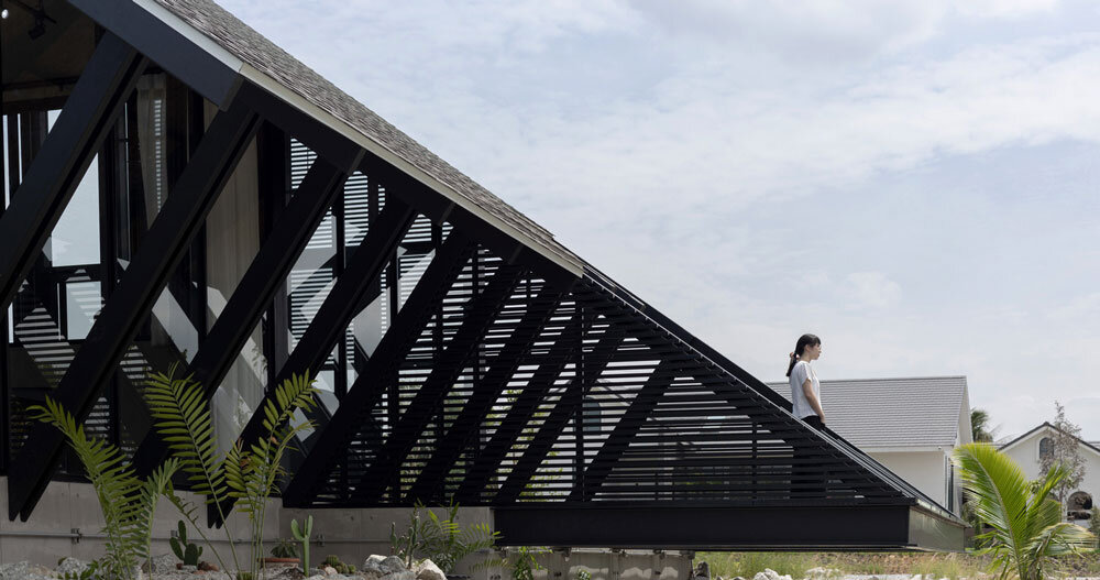 the sloping roof of TOUCH architect's 'villa backyard' directs rainwater