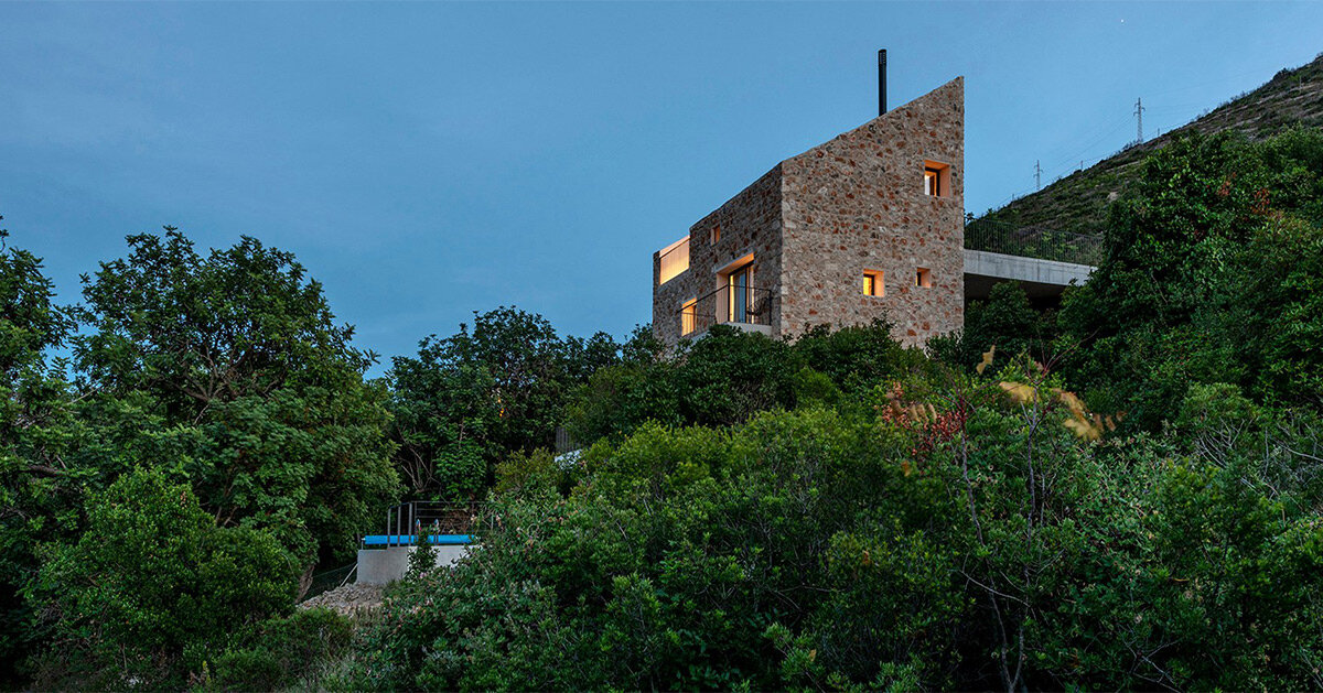 monolithic stone house by studio archaos emerges from verdant site on ...