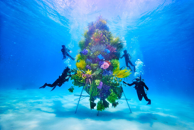 azuma makoto submerges botanical sculpture in clear blue waters