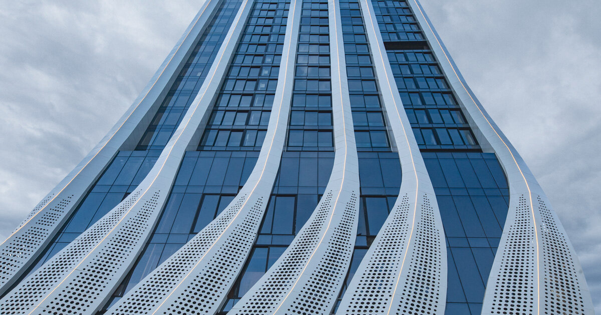 studio symbiosis clads tower in mumbai with calligraphic strokes