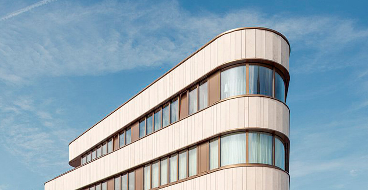 limestone & glass wrap around residential building in luxembourg