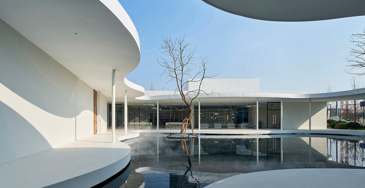 'white orchid pavilion' unravels exhibition booth in curved forms