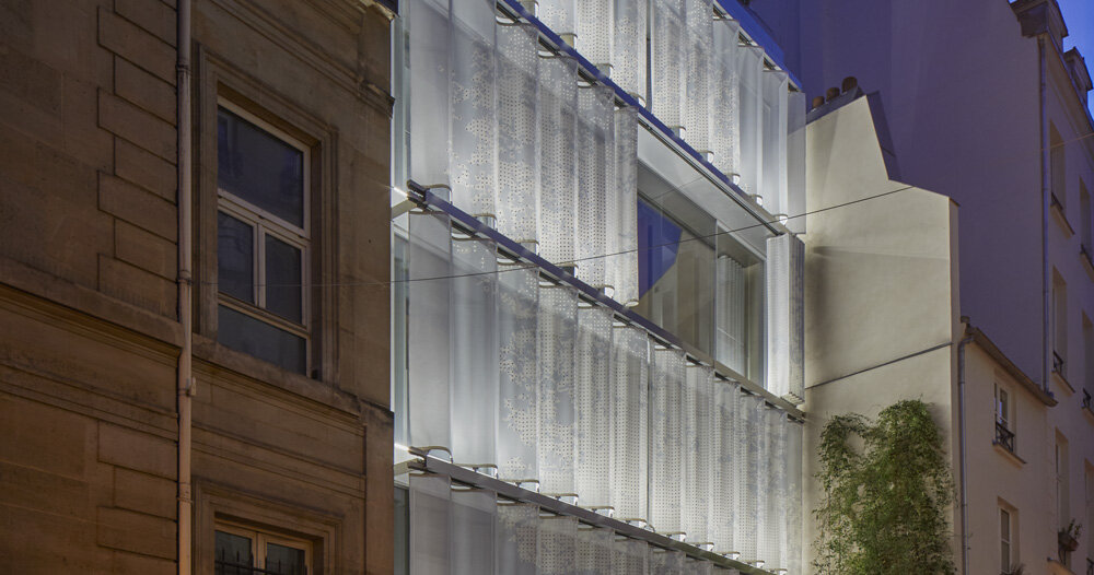 perforated textile façade by inside outside shrouds parisian building