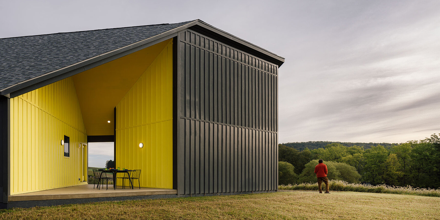 a dramatic yellow void defines 'oblong farm' by scalar architecture