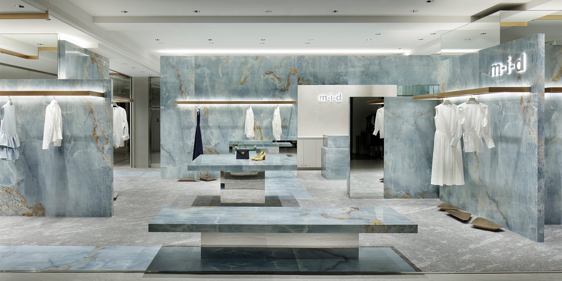 blue onyx slabs unfold within curiosity's m-i-d store design in kobe