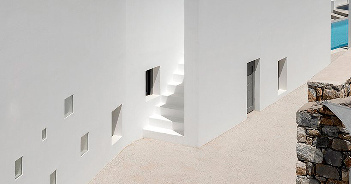 riza house's whitewashed walls emerge from arid greek landscape