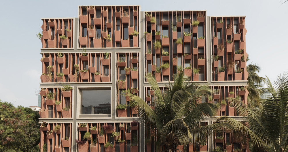 workspaces in india are wrapped in a living facade of stone planters