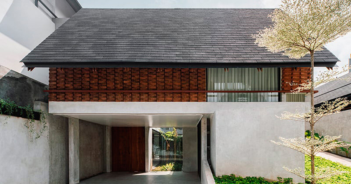 red brick lace-like facade coats the mass of ach house in jakarta