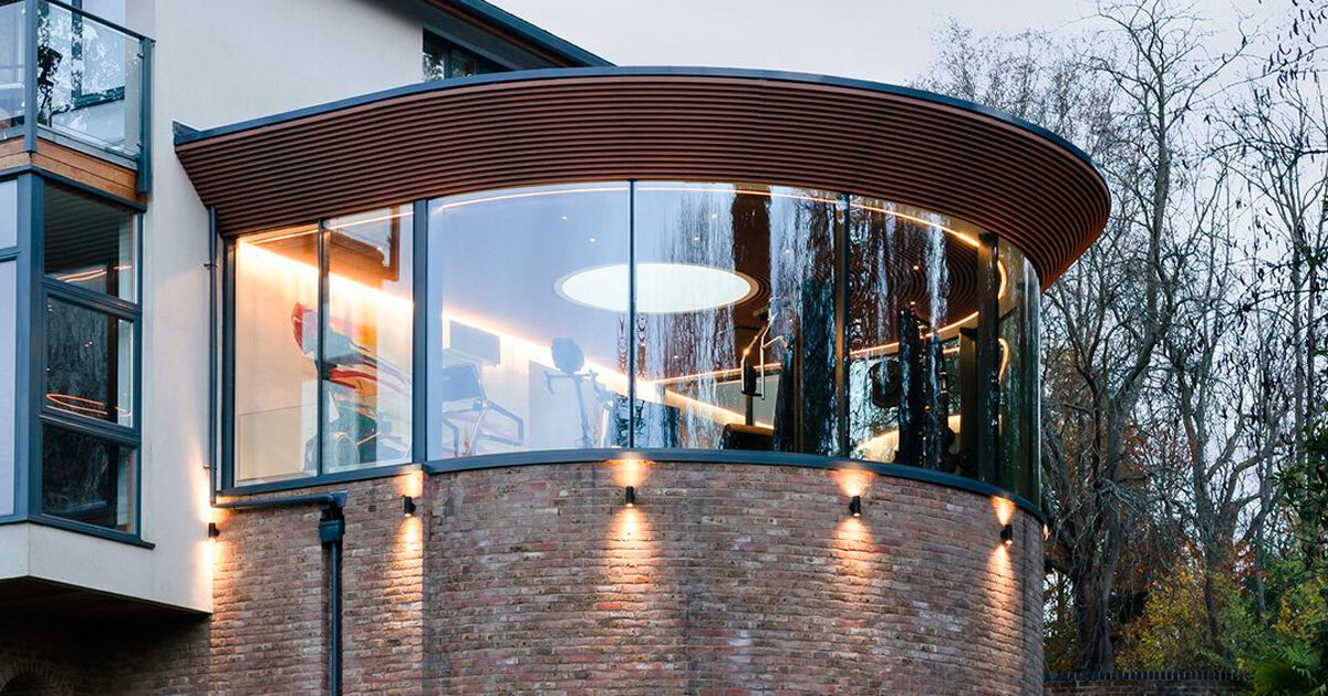 curved glass gym fit-out expands family residence in the uk