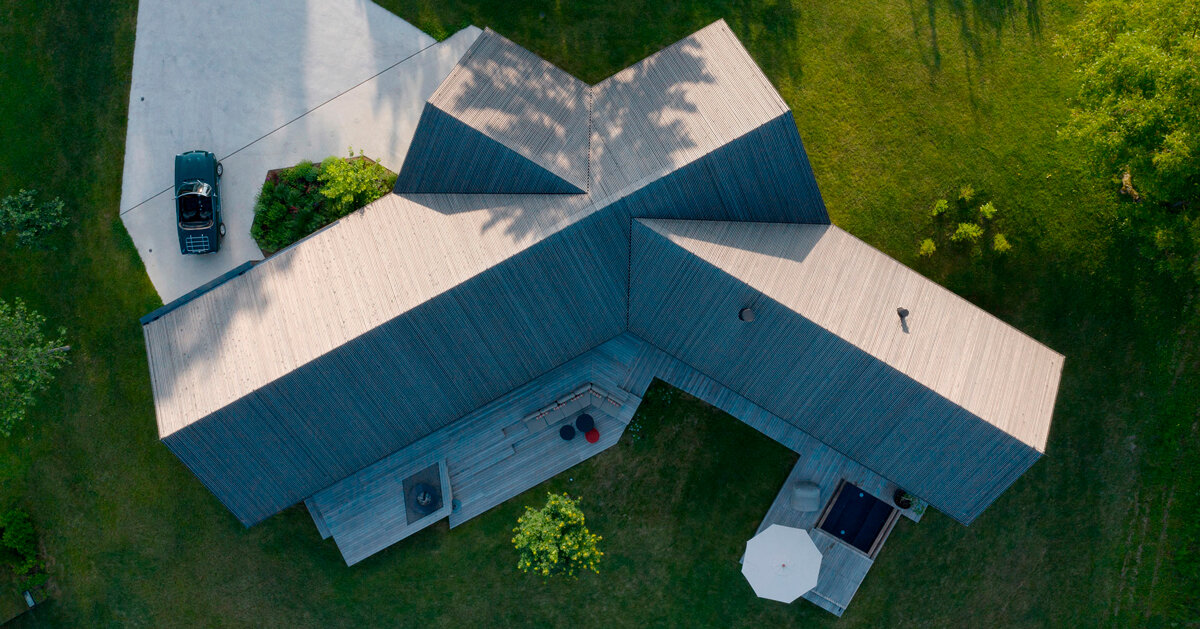 two intersecting saddle roofs shield DMAA's house f in slovenia