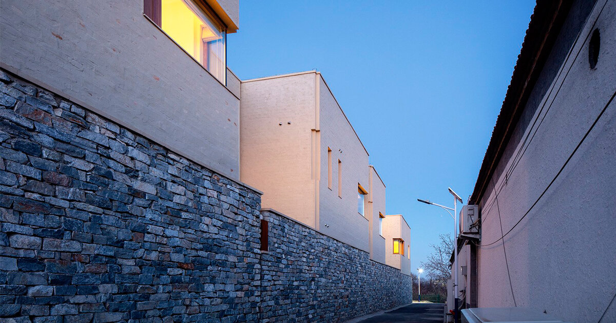 eight interconnected stone-clad buildings compose long circle B&B in ...