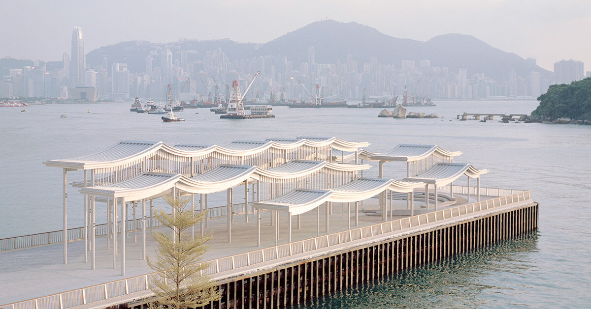 undulating canopy by new office works shelters waterfront promenade in hong kong