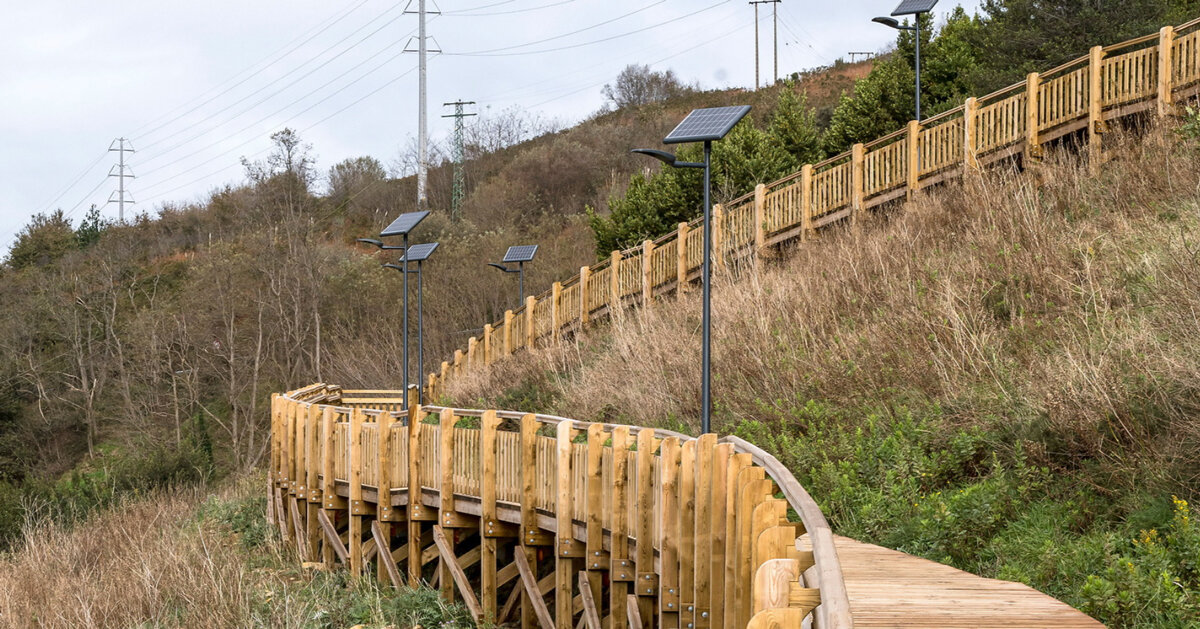 pedestrian wooden walkway on stilts traces hillside in bilbao