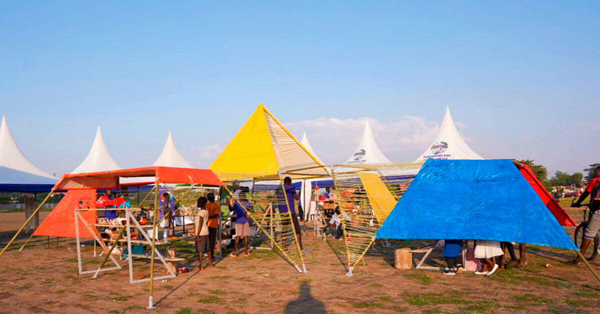 colorful angular tents shape puzzle-like zanya pavilion in uganda