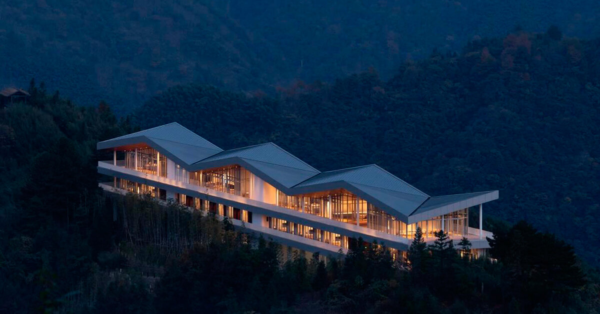 folded zinc roof undulates atop floating hotel by more architecture in ...