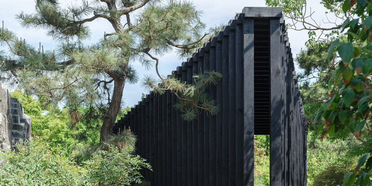 louvered wooden columns form temp's 3-to-1 triangular pavilion