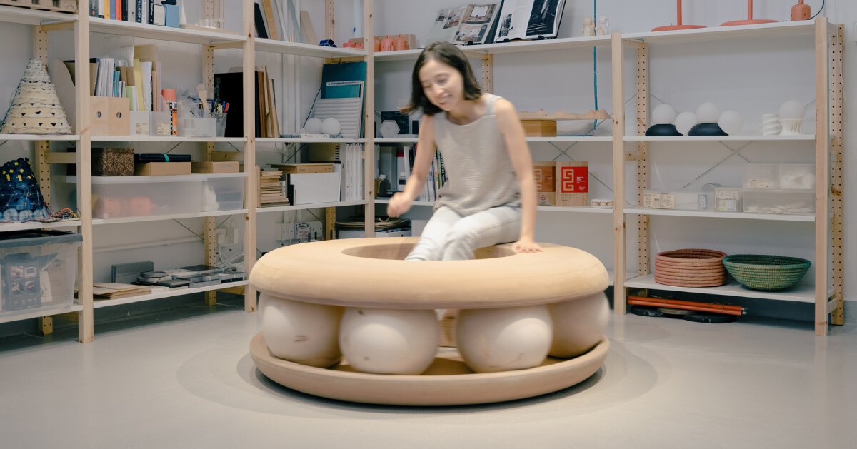 wooden balls set canalside studio's donut-shaped bench into motion