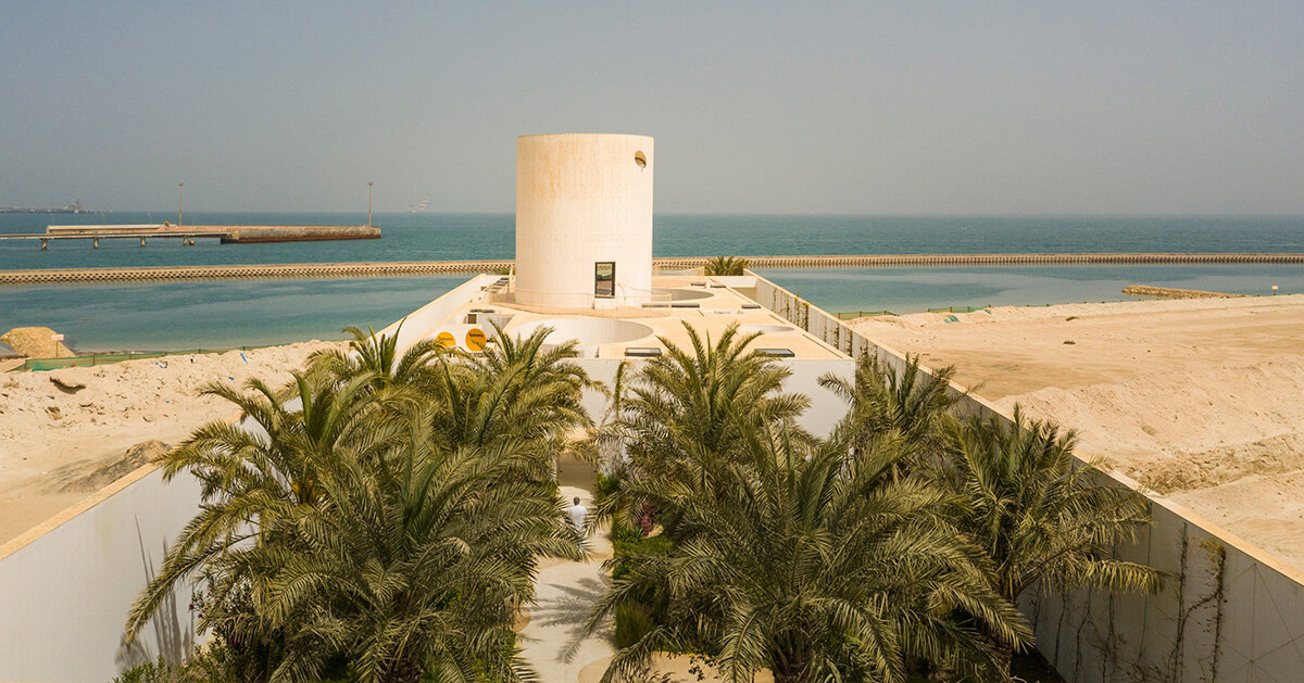 lighthouse-like tower rises amid white walls of TAEP/AAP's residence in ...