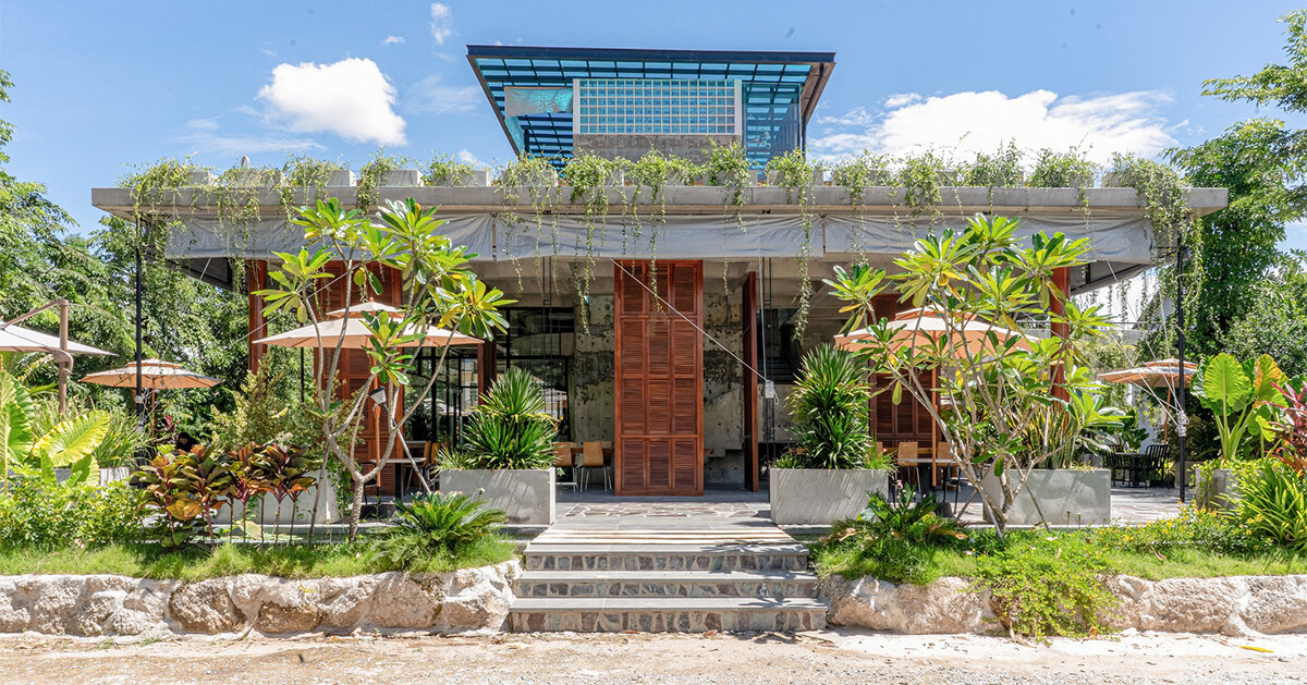 unfinished concrete structure turns into nature-filled tropical café in cambodia