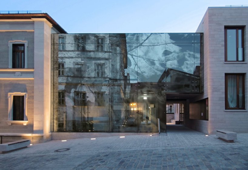 reiner john links historic building to extension with glass façade