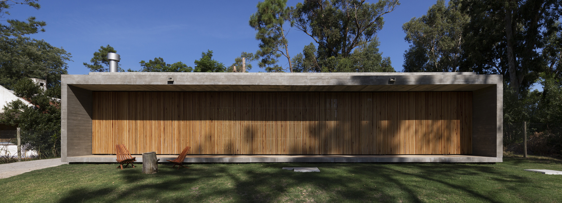 permeable house in uruguay features a slatted timber folding facade by ...