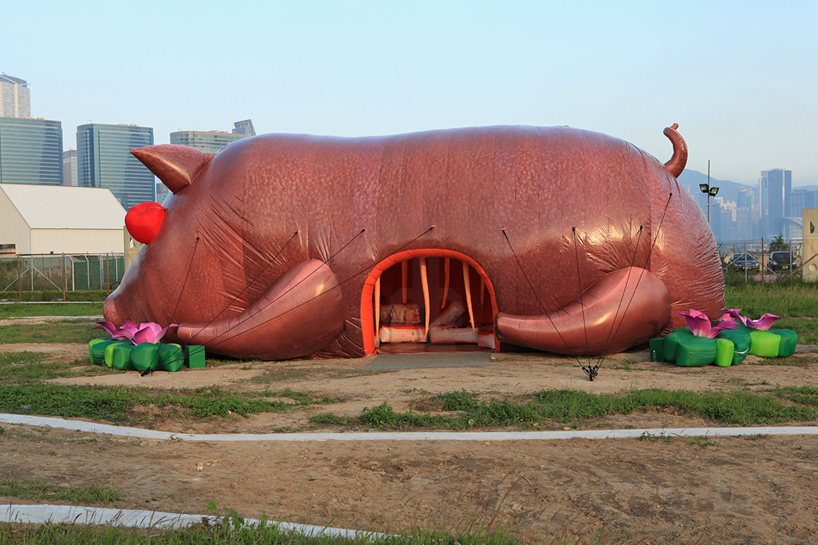 giant inflatable pile of poo, roast pig and stonehenge sculptures at M+