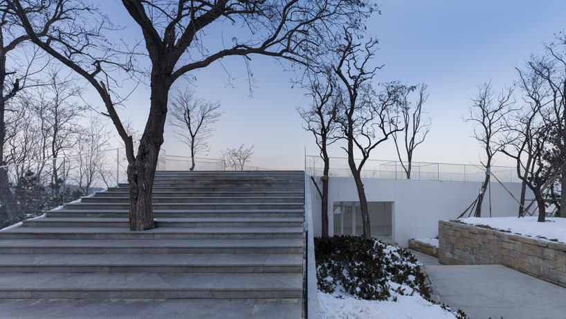 TAO: viewing pavilion on a hill in china rises from the woods