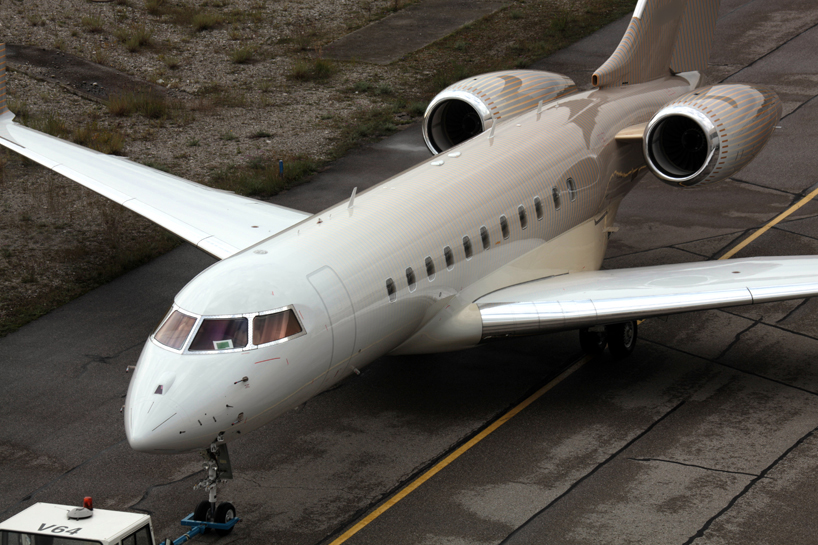 happy design studio wraps private jet in gradient stripe pattern