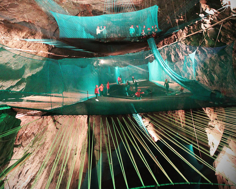massive underground trampolines are suspended within a welsh mining cavern